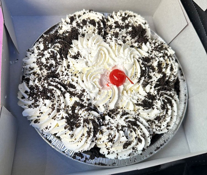 This cream pie with its chocolate cookie crumbles and cherry on top isn't just dessert—it's a celebration on a plate. Marie Antoinette would approve.