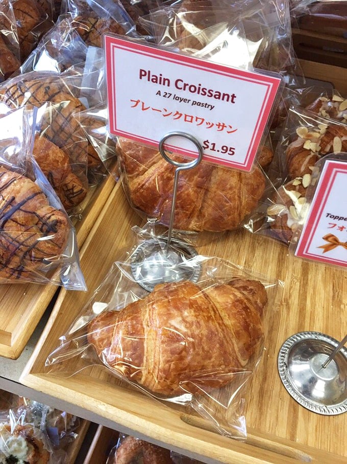 "A 27 layer pastry" the sign proudly declares – these golden croissants are proof that patience and butter create miracles.