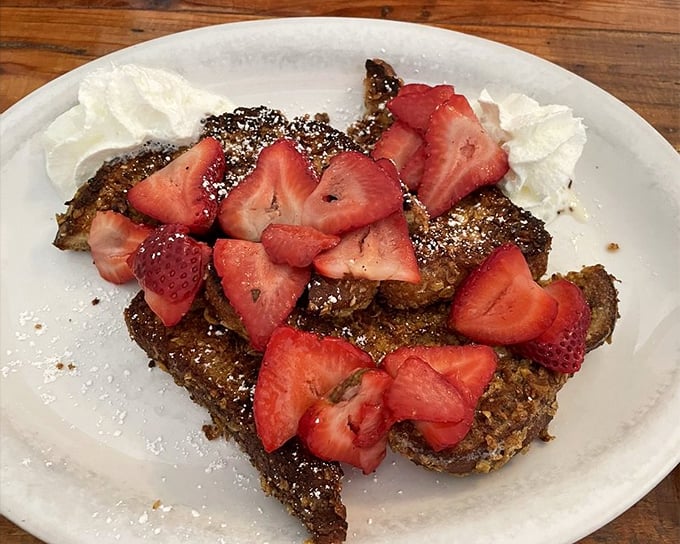 Crunchy French toast that's achieved celebrity status for good reason—those fresh strawberries aren't just garnish, they're co-stars.