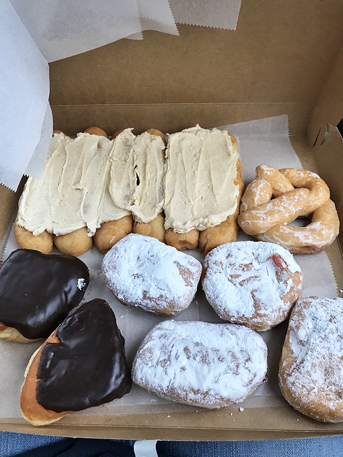 A box of joy containing frosted, glazed, and chocolate-dipped donuts. Notice how they're arranged like precious artifacts—which in the pastry world, they are.