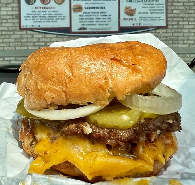 Behold the double cheeseburger in its natural habitat—melty American cheese cascading over perfectly grilled patties like a dairy waterfall of dreams.