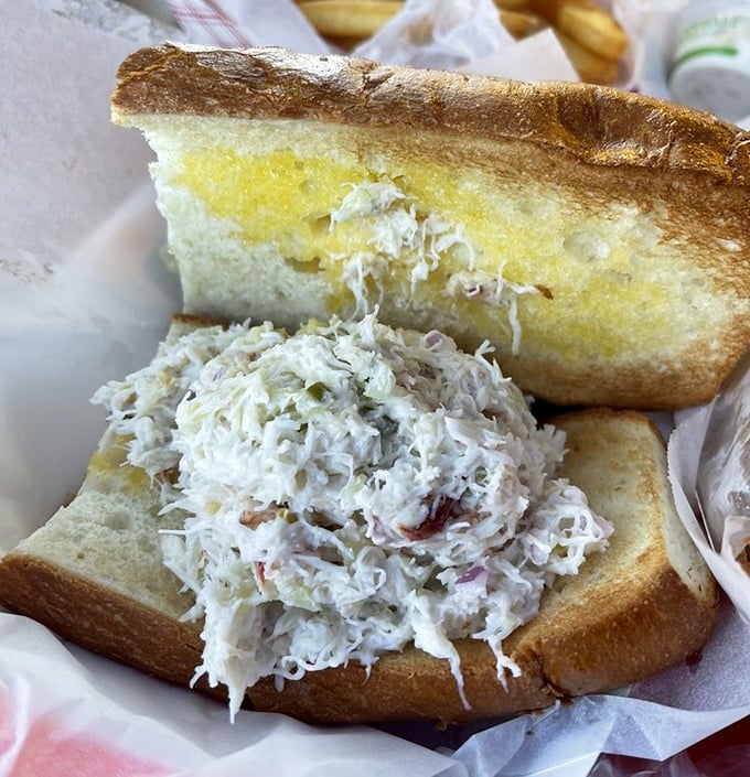 This crab sandwich isn't just a meal—it's an engineering marvel. Sweet Dungeness crab piled so high it requires strategic planning just to take the first bite.