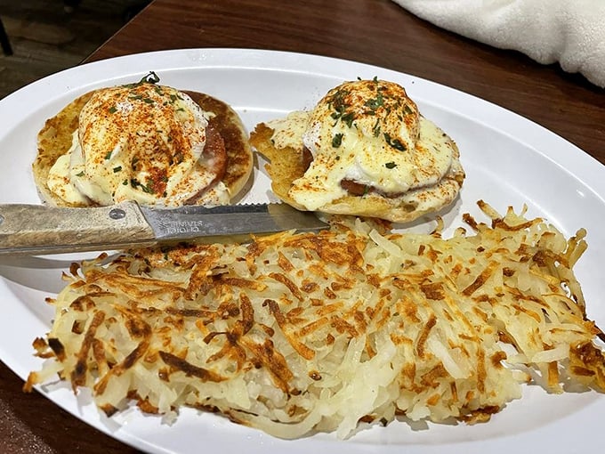 Eggs Benedict with perfectly crispy hash browns – a breakfast that says "today might be ordinary, but your first meal won't be."