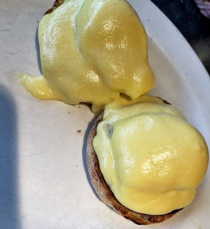 Eggs Benedict done right, with hollandaise that cascades like edible sunshine over perfectly poached eggs.