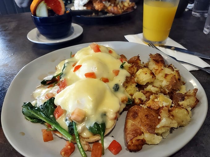 Benedict done right is poetry on a plate. Hollandaise cascading over perfectly poached eggs with spinach and tomato—a morning masterpiece worth the wait.