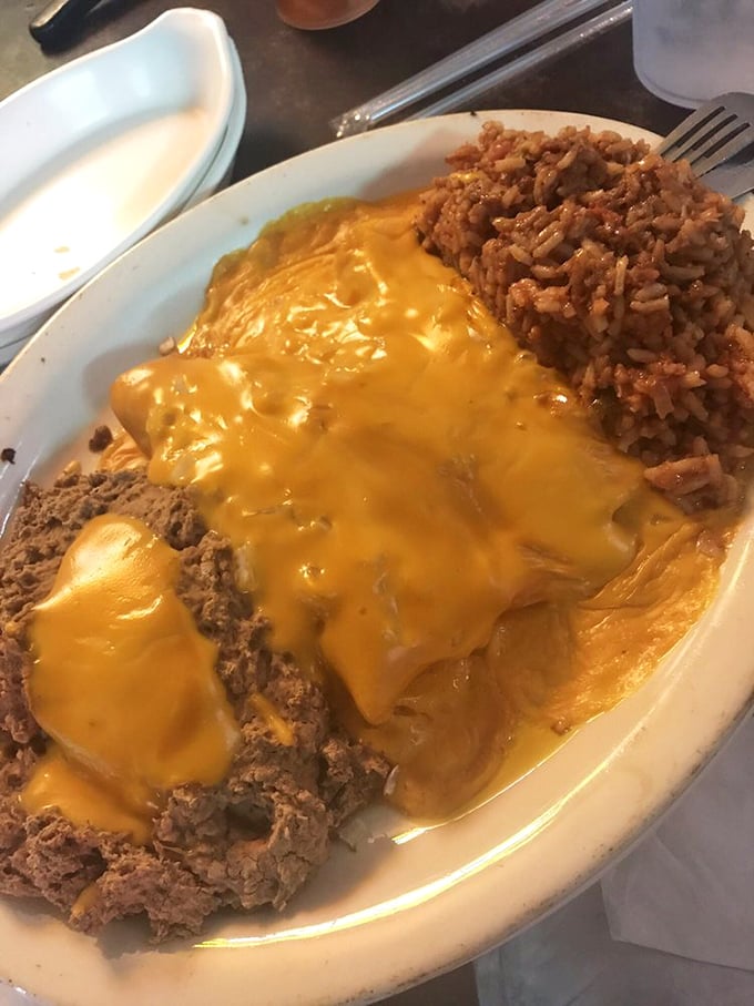 Cheese-smothered enchiladas with Spanish rice – proof that Mary's Cafe doesn't just excel at American classics but ventures confidently across culinary borders.