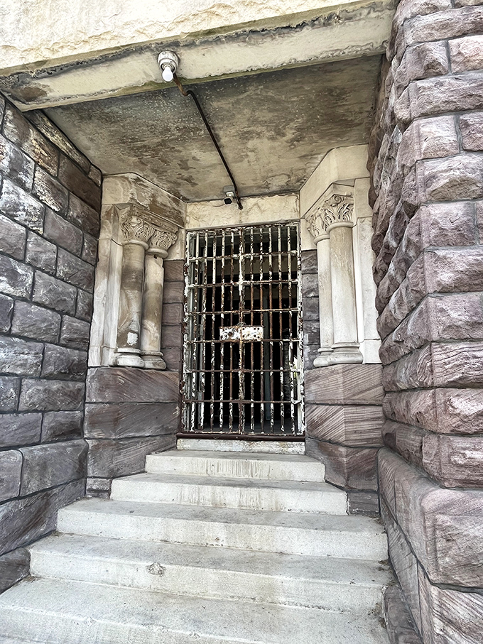 The entrance says "welcome" in the least welcoming way possible. Those stone columns and iron bars weren't designed for comfort—they were built to intimidate.
