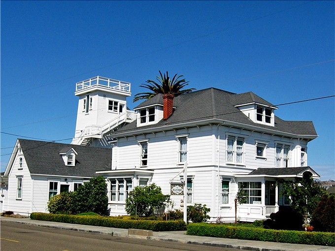 This classic white Victorian with its observation tower looks like it's waiting for a seafaring captain to return from a long voyage.