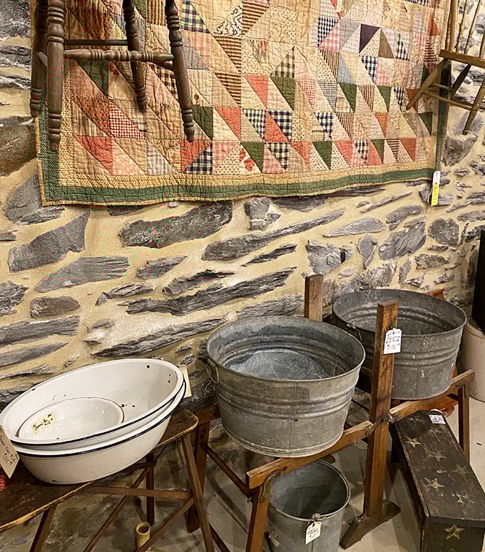 A handmade quilt draped over galvanized wash tubs—this vignette tells more about American domestic life than most history textbooks ever could.