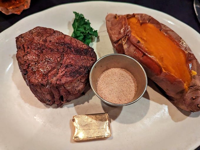 Filet mignon with sweet potato and seasoning on the side—proof that sometimes the simplest preparations let truly great ingredients shine brightest.