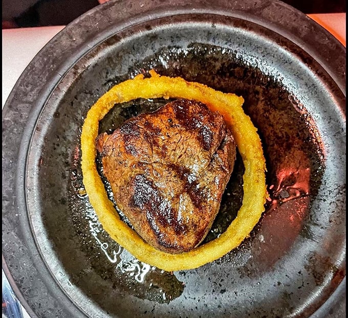 A filet mignon surrounded by a golden onion ring—like Saturn with its rings, but infinitely more delicious and definitely worth the trip.
