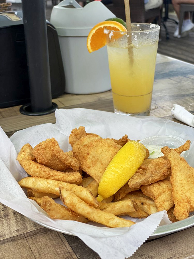 Golden-fried fish and chips with a cold drink – proof that simple pleasures are often the most satisfying.