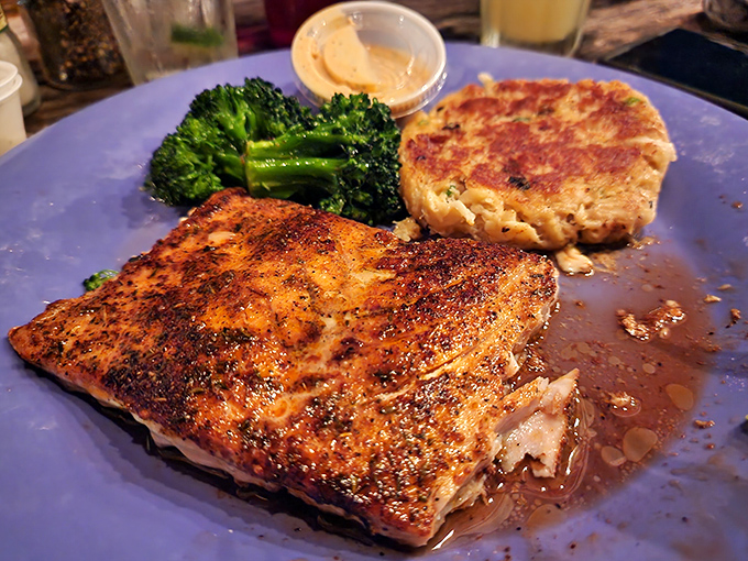 This isn't just fish – it's Florida on a plate, where blackened seasoning meets flaky perfection and broccoli pretends to matter.