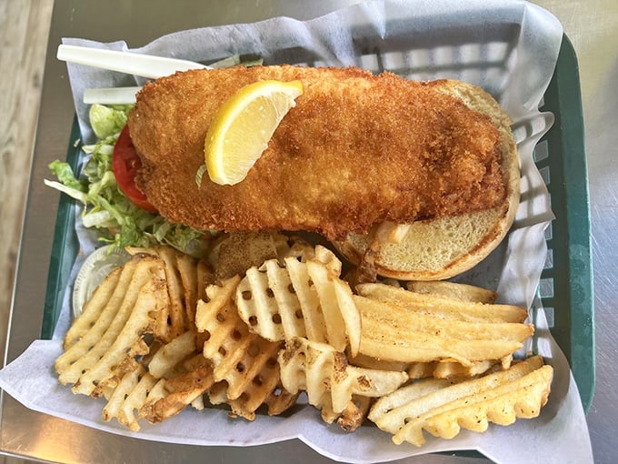 The fish sandwich that launched a thousand return visits, nestled in its basket like Neptune's treasure. Those waffle fries deserve their own fan club.