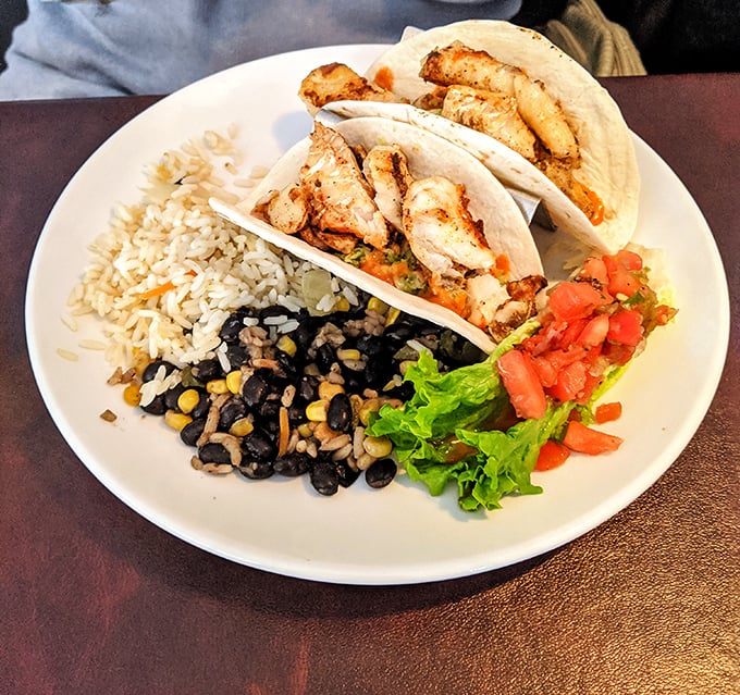 Fish tacos that bring coastal flavors inland, served with rice and beans that refuse to be mere supporting actors.