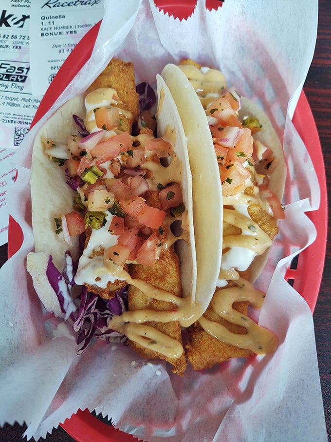 Fish tacos that bring the beach to you – crispy fish, fresh slaw, and a drizzle of sauce that ties it all together like a culinary bow.