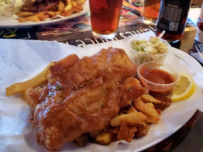 Fish and chips done right—golden-battered fish alongside thick-cut fries, with coleslaw standing by like a loyal sidekick.