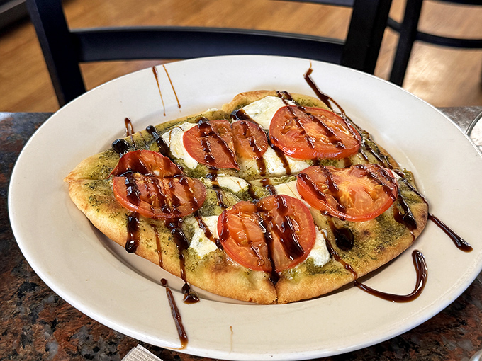 This flatbread proves that sometimes the simple combination of fresh tomatoes, cheese, and a drizzle of balsamic is all you need for culinary bliss.