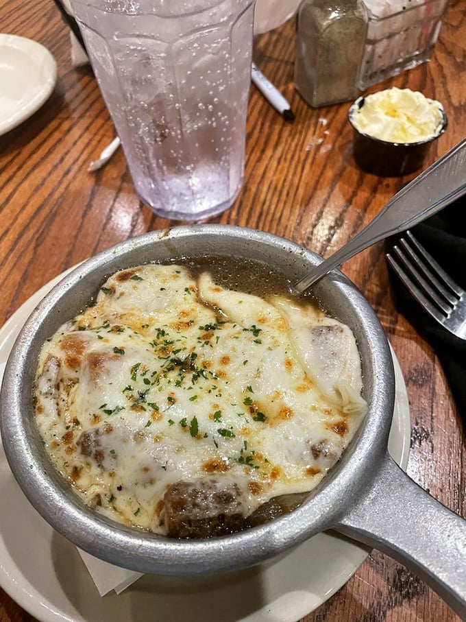 This isn't just French onion soup—it's a cheese-capped cauldron of comfort that makes you forget you're in Tennessee, not a Parisian bistro.