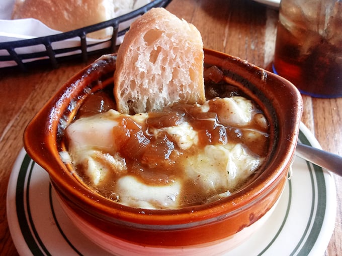 French onion soup that's worth the cheese pull. Caramelized onions swimming beneath a melty provolone blanket with a crusty bread island—soup nirvana achieved.