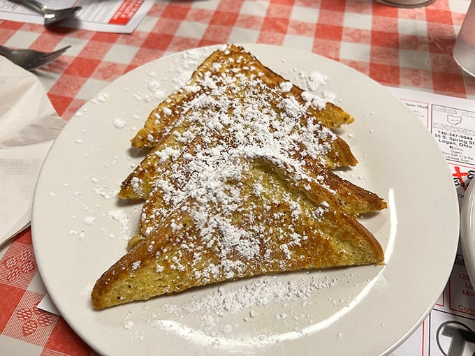 French toast dusted with powdered sugar—simple perfection that doesn't need fancy ingredients or techniques, just someone who knows what they're doing.