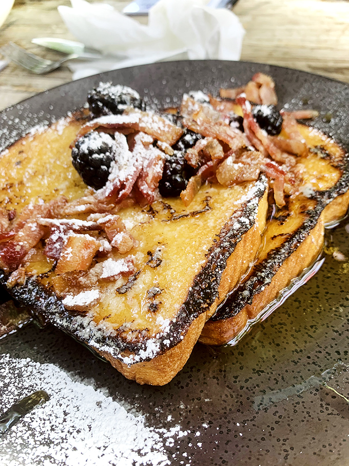 French toast that's had more thought put into it than most people's retirement plans. Those berries aren't garnish—they're co-stars.