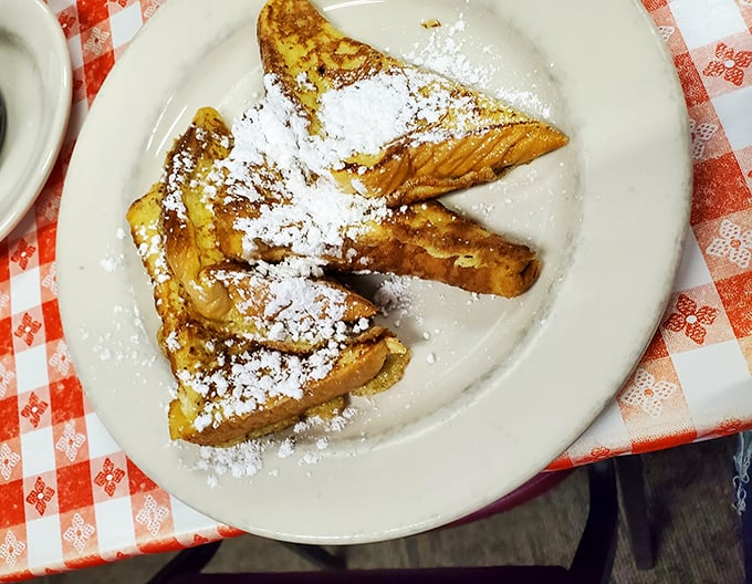 French toast dusted with powdered sugar snow – simple perfection that reminds you why classics became classics in the first place.