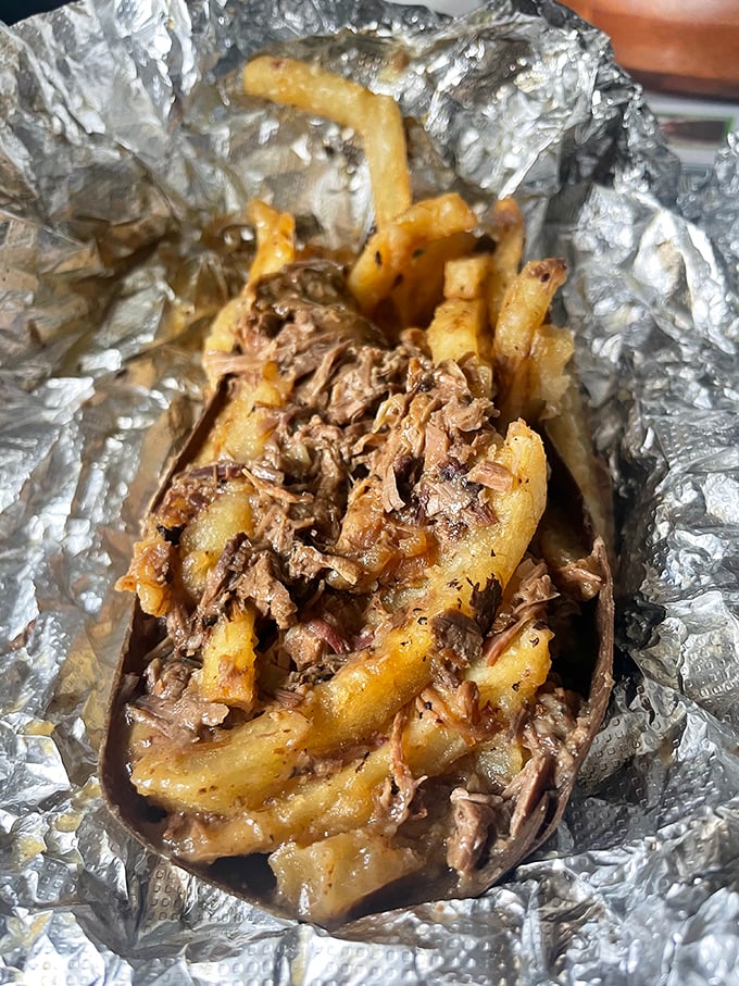 The foil-wrapped treasure of beef-topped fries might not win beauty contests, but one bite and you'll understand why locals keep this spot sacred.