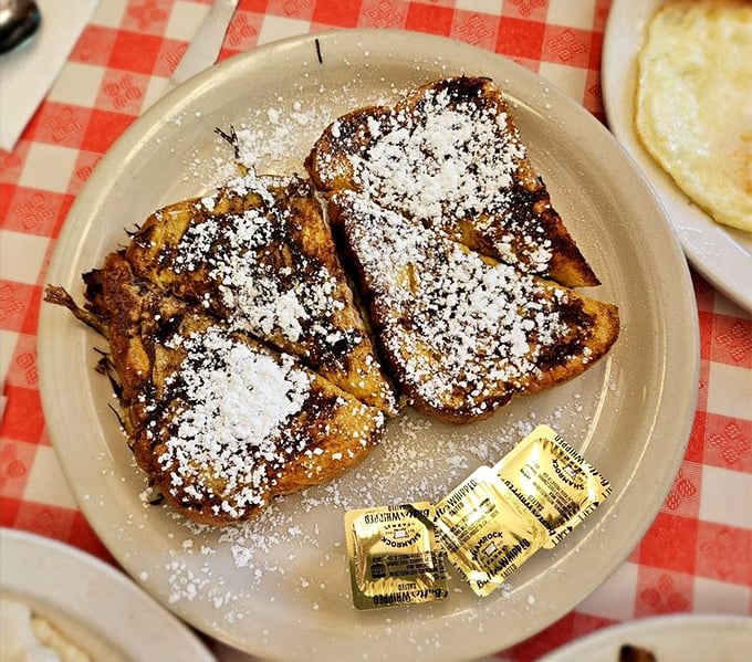 French toast dusted with powdered sugar – the breakfast equivalent of wearing pajamas to a fancy party. Deliciously rebellious and absolutely worth it.
