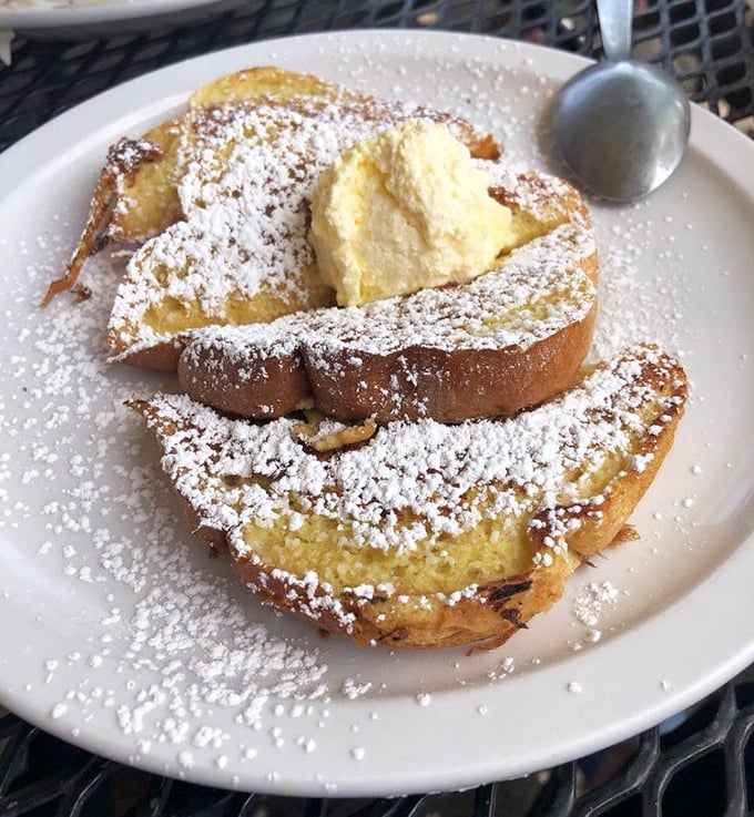 French toast that makes you question why anyone would ever settle for regular toast again – dusted with powdered sugar like fresh Missouri snow.