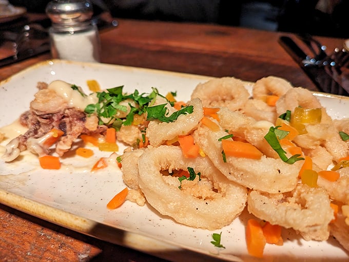 Calamari that doesn't hide behind excessive breading—a refreshing change from the rubber-band texture that haunts lesser establishments. The colorful garnish isn't just for show.
