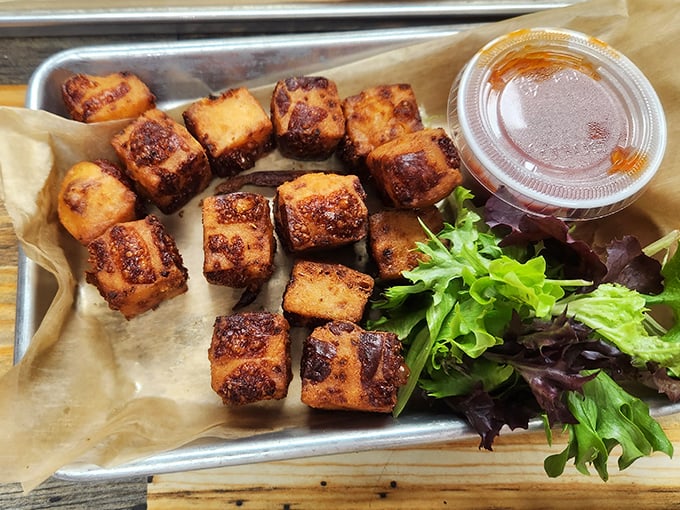 These aren't just any cheese curds—they're golden-brown nuggets of joy with a side of greens for those who need to pretend they're eating healthy.