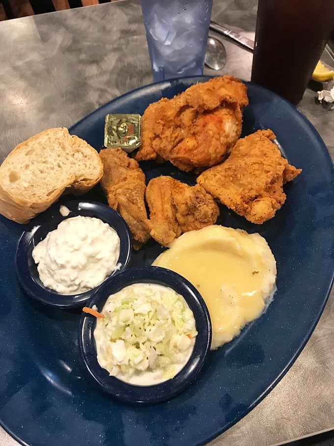 Fried chicken that looks like it belongs in a museum of comfort food perfection—golden, crispy exterior hiding juicy meat, with sides that know their supporting role.