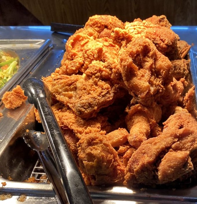 The fried chicken mountain—where crispy, golden-brown pieces wait patiently for you to make the difficult choice of thigh versus drumstick.