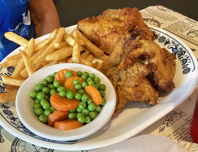 Fried chicken that achieves the impossible trifecta: crispy exterior, juicy interior, and the power to silence a table of chatty Floridians.