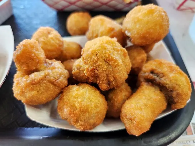 These golden-fried mushrooms aren't trying to be truffle frites or some fancy appetizer—they're just delicious little flavor bombs waiting to burn the roof of your mouth.