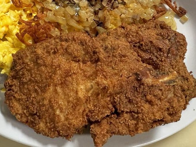 Country fried pork chop with eggs and hash browns – the kind of breakfast that makes you want to skip lunch and dinner. 