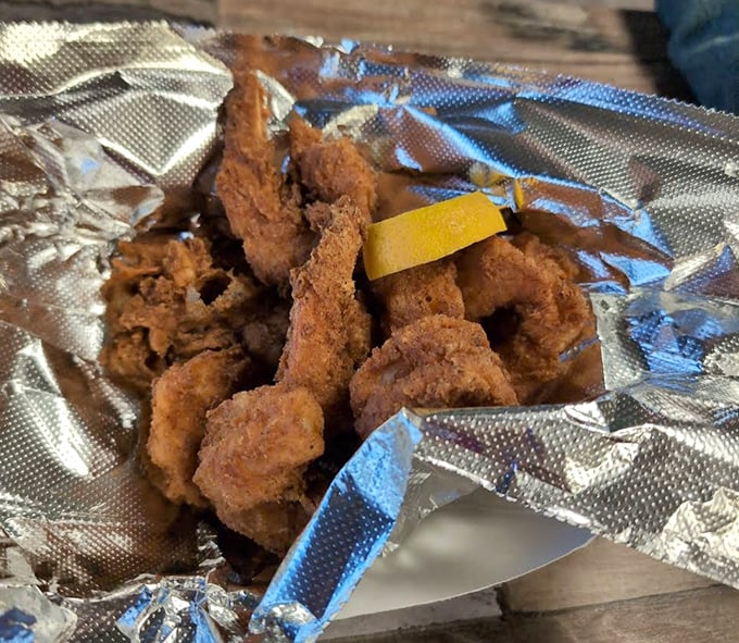 Fried shrimp so perfectly golden they practically glow, offering that ideal balance of crispy exterior and succulent interior that keeps seafood lovers coming back.