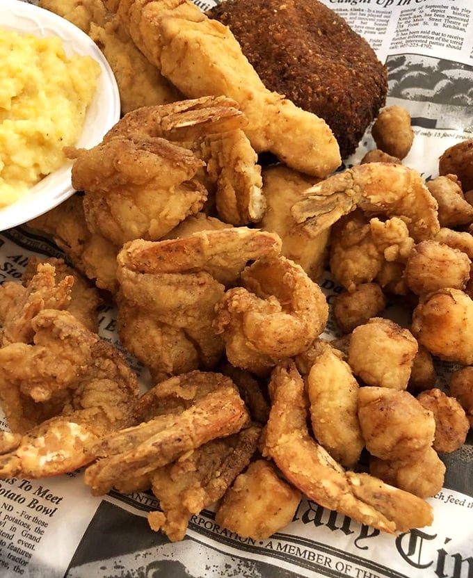 Golden-fried shrimp piled high on newspaper—the way seafood was meant to be enjoyed. No pretension, just perfection.