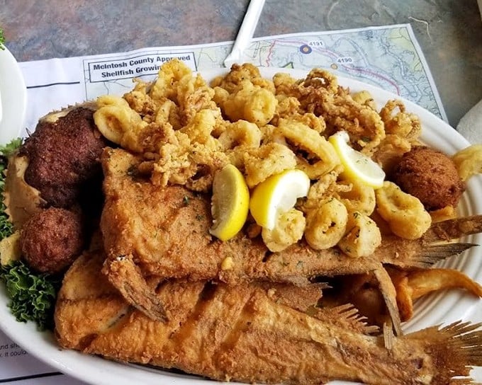 The ultimate seafood sampler—fried shrimp, fish, and hushpuppies arranged like a delicious treasure map where X marks every spot.