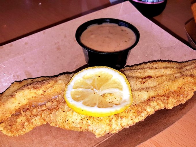 Fried catfish that would make a Southern grandmother nod in approval. That lemon slice isn't decoration—it's the perfect acidic counterpoint.