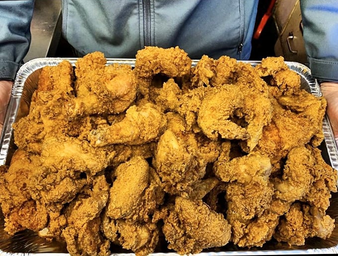 Behold the mountain of fried chicken that dreams are made of. This isn't just dinner—it's a celebration on a tray.