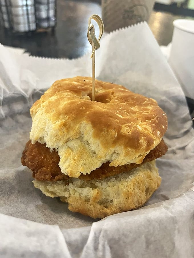 This biscuit sandwich isn't messing around. Golden, flaky architecture supporting a perfectly fried chicken centerpiece—breakfast engineering at its finest.