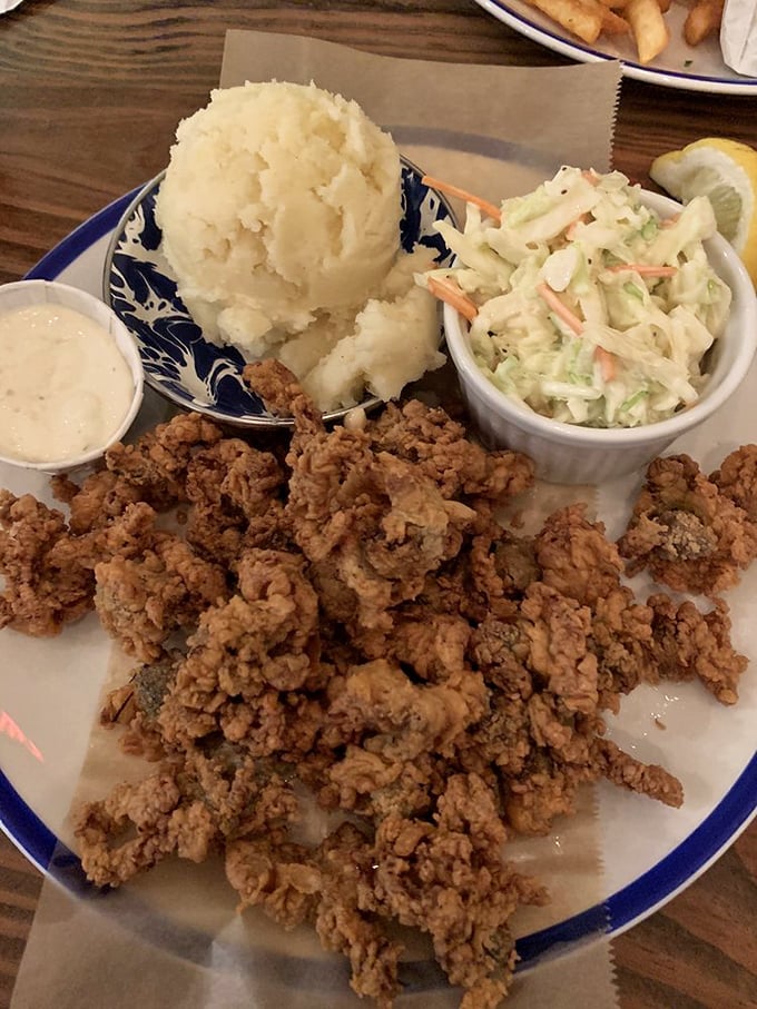 These fried clams aren't just crispy—they're the reason elastic waistbands were invented, served with sides that know their supporting role.