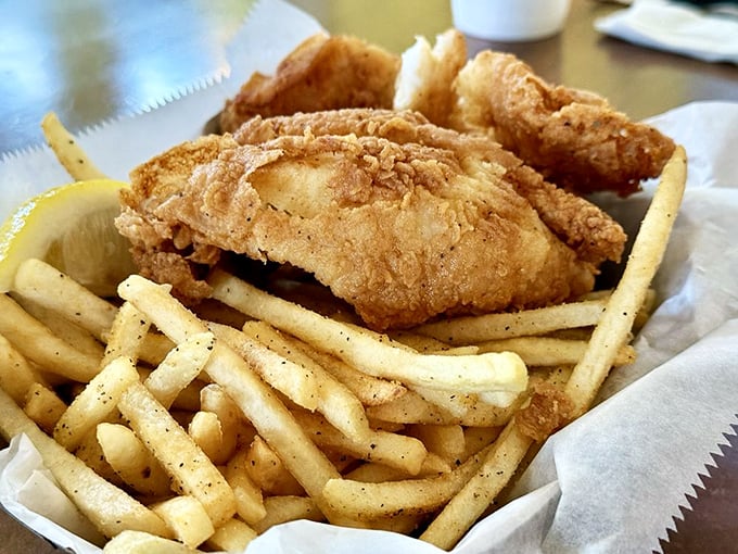 Golden-fried fish resting on a bed of fries—proof that sometimes the simplest combinations create the most profound happiness.