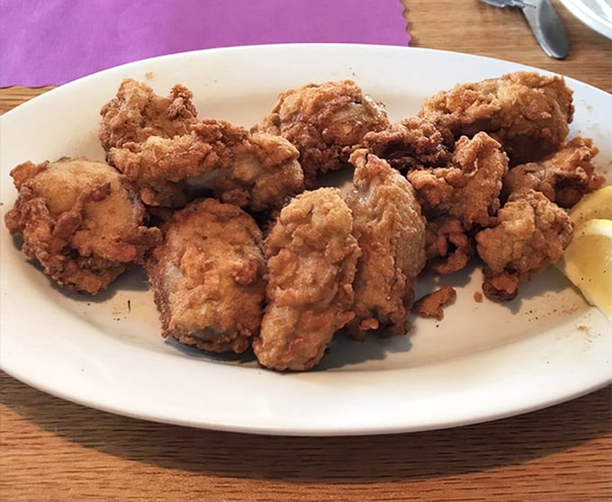Fried oysters that could convert non-believers—crispy armor protecting briny jewels within. The lemon wedge isn't a suggestion; it's the perfect finishing touch.