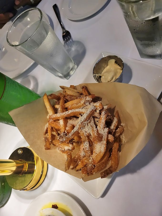 Parmesan truffle fries: where potato meets luxury in a paper-lined basket. The kind of side dish that steals focus from the entrée.