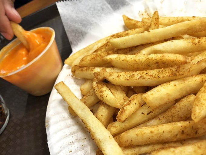 These golden fries dusted with seasoning aren't just a side—they're a dippable delivery system for that glorious cheese sauce.