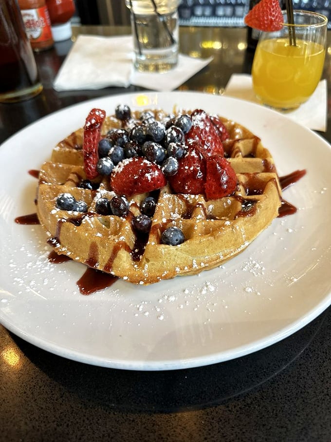 Fresh berries transform an ordinary waffle into an extraordinary one—nature's candy scattered across golden squares of breakfast perfection.