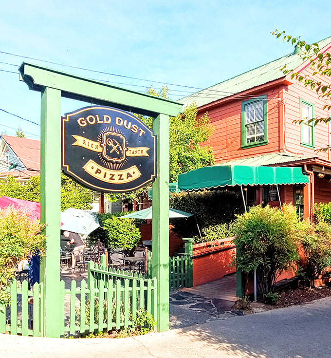Gold Dust Pizza's garden patio beckons with the promise of wood-fired delights—the green picket fence is just the first hint of the charm awaiting inside.